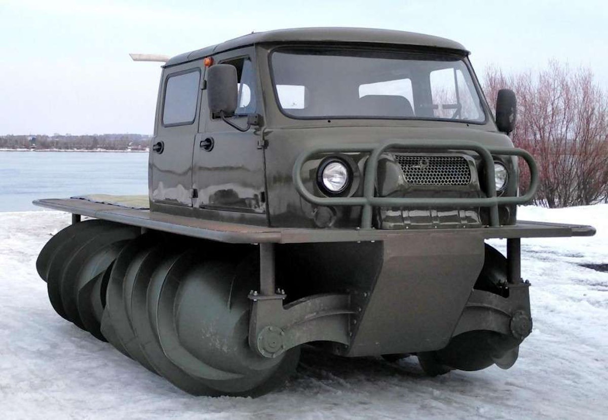Restored Soviet screw-propelled truck takes on land and water ...
